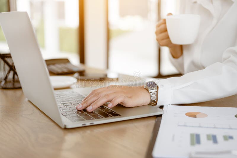 Close Up Business Hands Typing on Laptop and Holding Coffee Cup ...