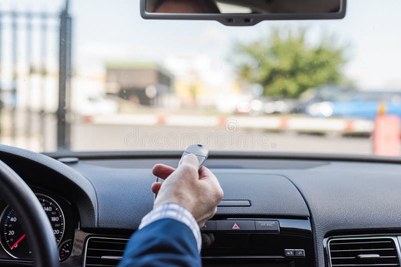 Close - Up Business Man Hand Using Remote Control for Opening Automatic ...