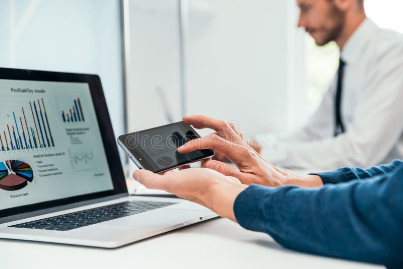 Close Up. Business Man Using His Smartphone To Analyze a Financial ...