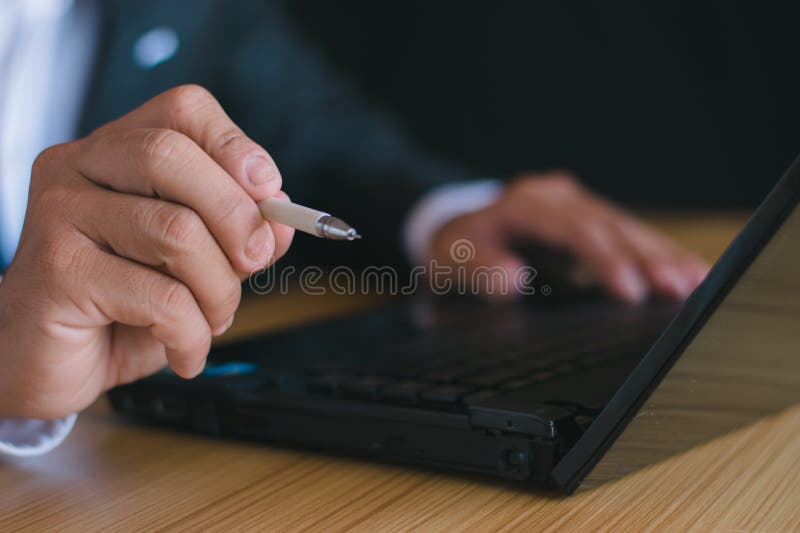 Close-up of Business People Working with Notebook Computers and Using ...