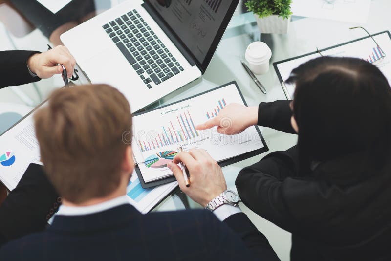 Close Up.business Team Analyzing Financial Schedules. Rear View Stock ...