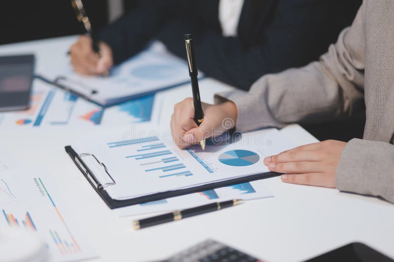 Close Up of Business Team Analyzing Income Charts and Graphs with ...