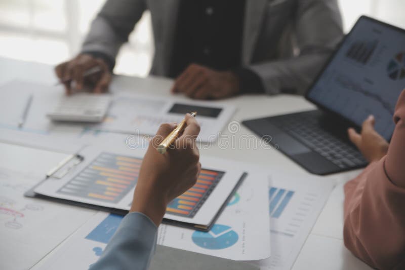 Close Up of Business Team Analyzing Income Charts and Graphs with ...