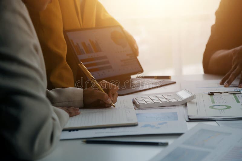 Close Up of Business Team Analyzing Income Charts and Graphs with ...