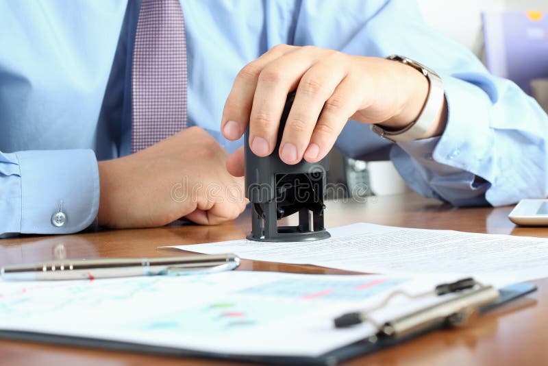 Close-up of Businessman Hand Pressing a Stamp on Document in Th Stock ...