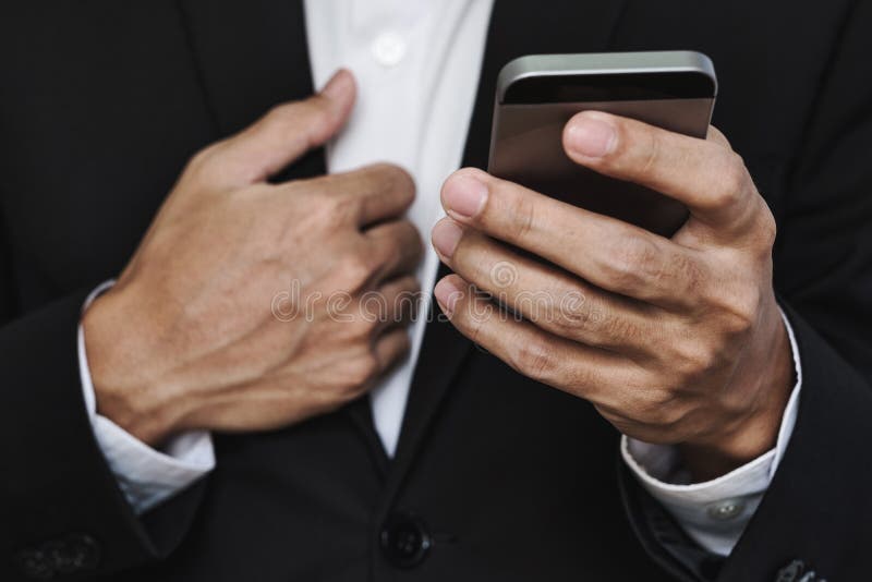 Close-up Businessman Hand Using Smart Phone, with Another Hand Holding ...
