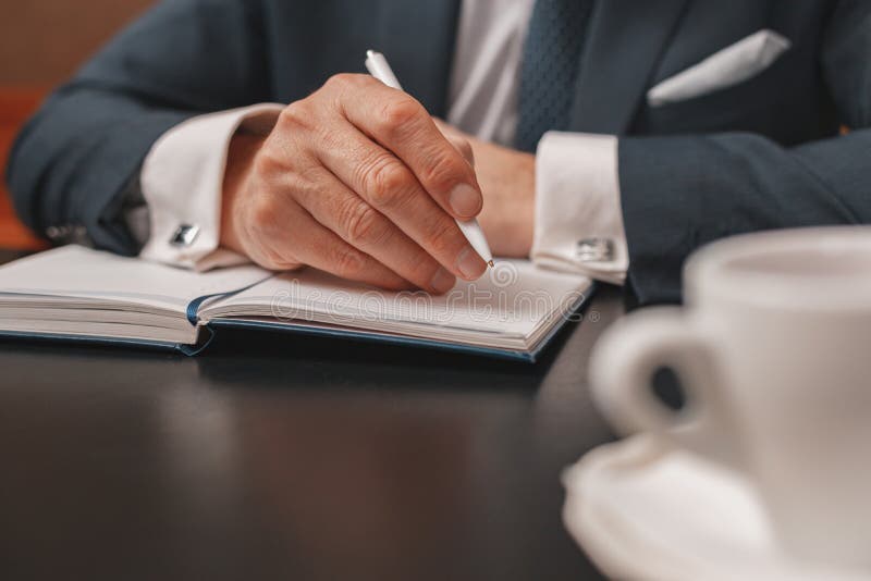 Close Up of Businessman Hands Making Notes in Diary during Meeting ...