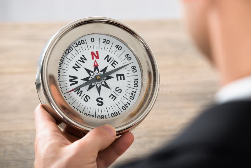Close-up of Businessman Holding Compass in Office Stock Image - Image ...