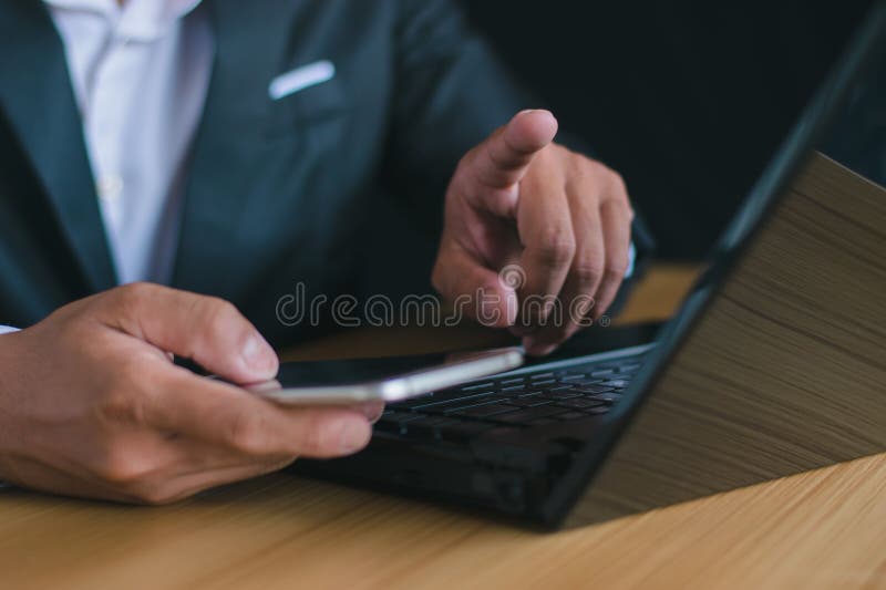 Close-up of a Businessman Working with a Notebook Computer and Pointing ...