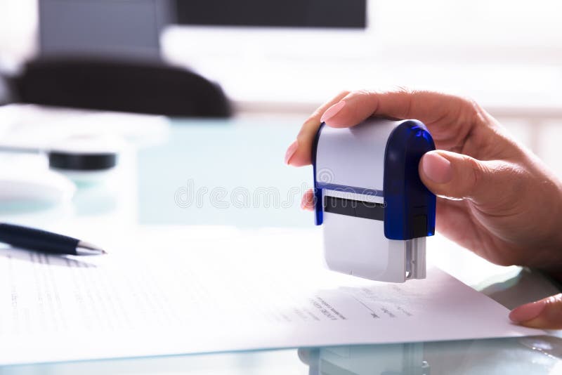 Businessperson Stamping Document in Office Stock Image - Image of ...
