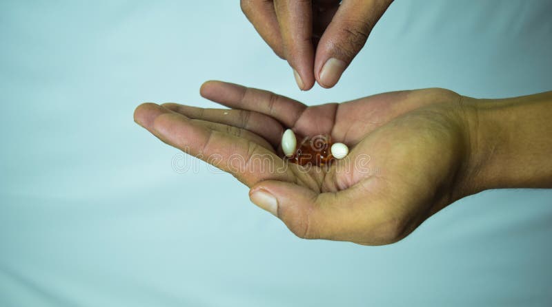 Capsule in hand stock image. Image of skin, nose, head - 222168395