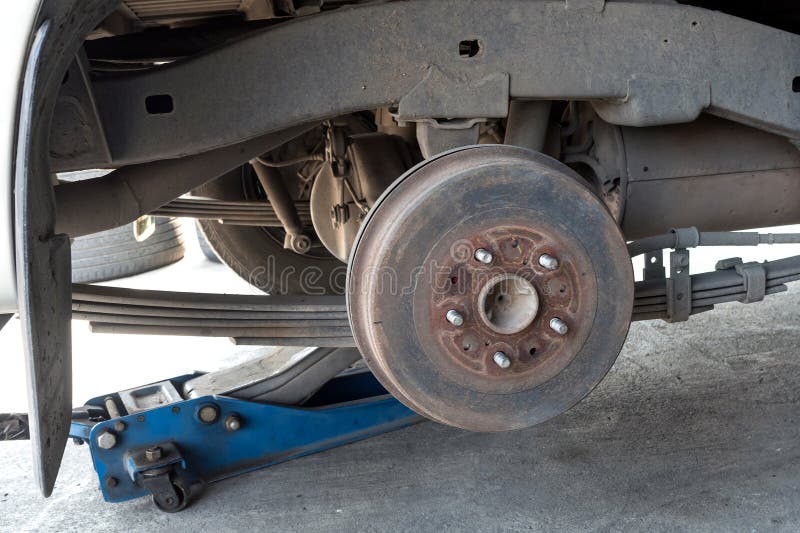 Close Up of a Car Brake and a Jack during Car Maintenance, Car Lifted ...