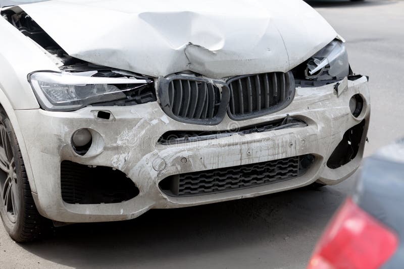 Close-up: a Car with a Busted Headlight and Dented the Hood after a ...