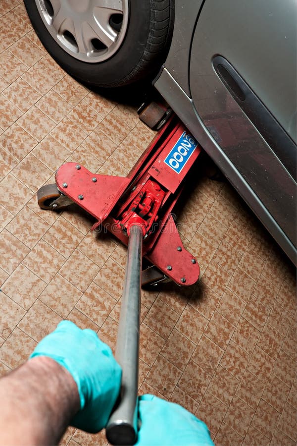 Close Up of Car Lifted with Car Jack at Auto Mechanic Workshop. Stock ...