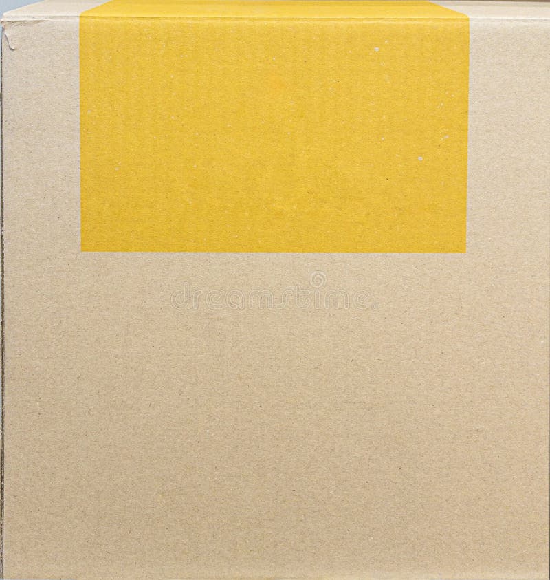 A Cardboard Box with a Large Yellow Adhesive Label Stock Photo - Image ...