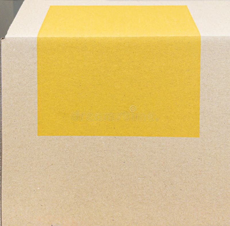 A Cardboard Box with a Large Yellow Adhesive Label Stock Image - Image ...