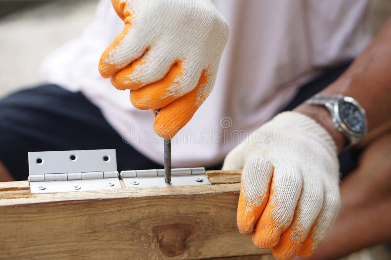Close Up Carpenter Hands are Installing Hinge on Wooden Window. Stock ...