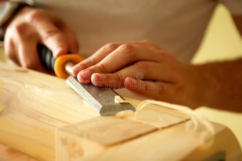 A Close-up of a Carpenter Hands Skillfully Using a Chisel on a Wooden ...