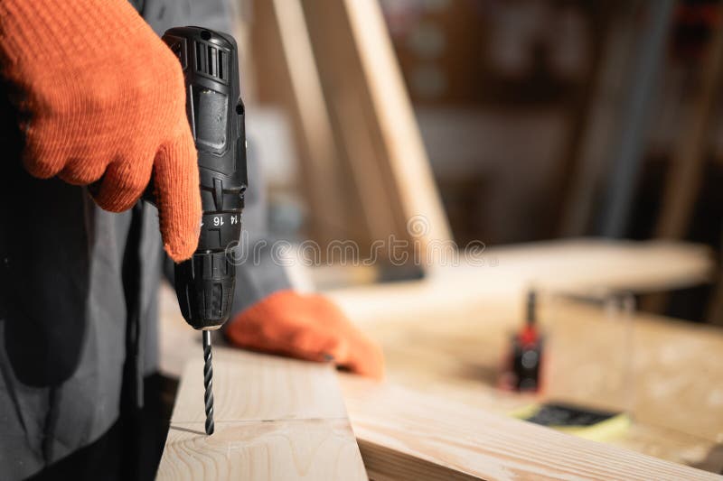 Close Up of Carpenter Using Electric Drill on Wood while Working in His ...
