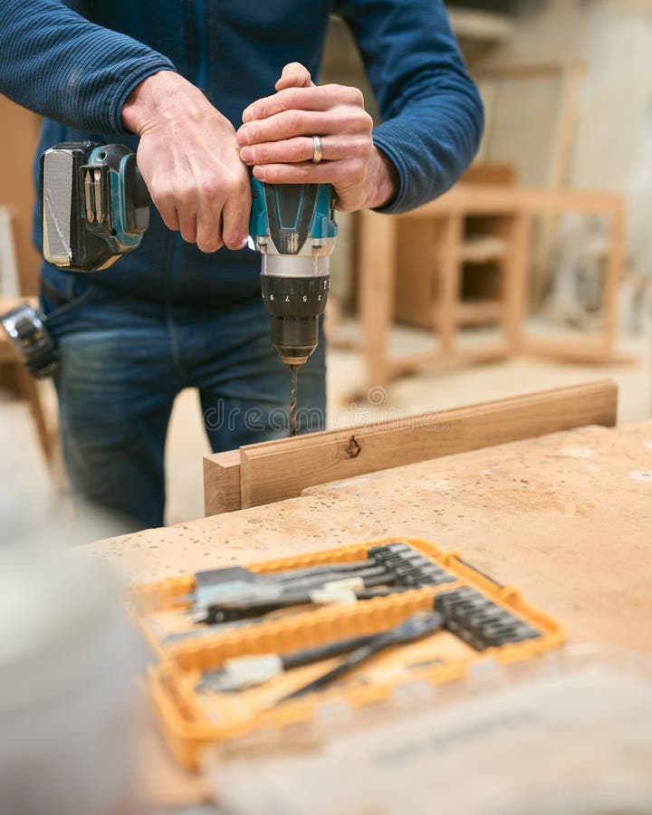 Close Up of Carpenter at Workbench in Workshop Using Cordless Electric ...