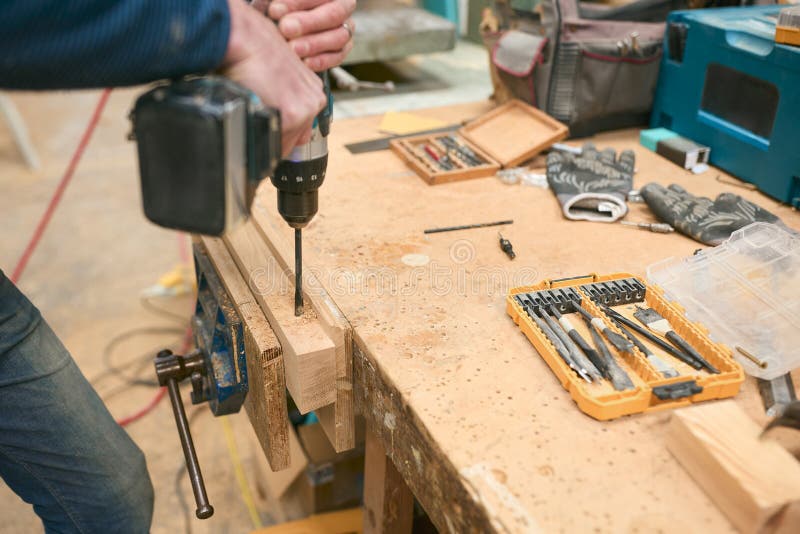 Close Up of Carpenter at Workbench in Workshop Using Cordless Electric ...