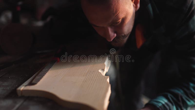 Close-up of a Carpenter Working on a Wooden Window Frame with a File in ...