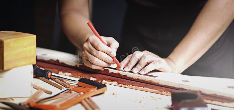 Close Up Carpenter Working in Woodworking Workshop. Making Line Stock ...