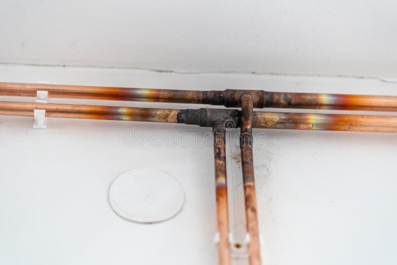 Close Up on Central Heating Copper Pipes with Copy Space on the Wall ...