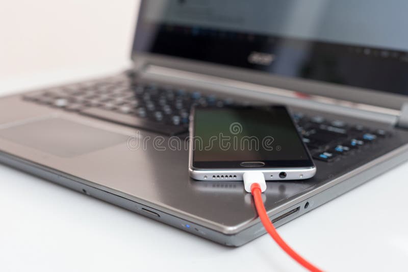 Close-up of Charging a Smartphone from a Laptop Stock Photo - Image of ...