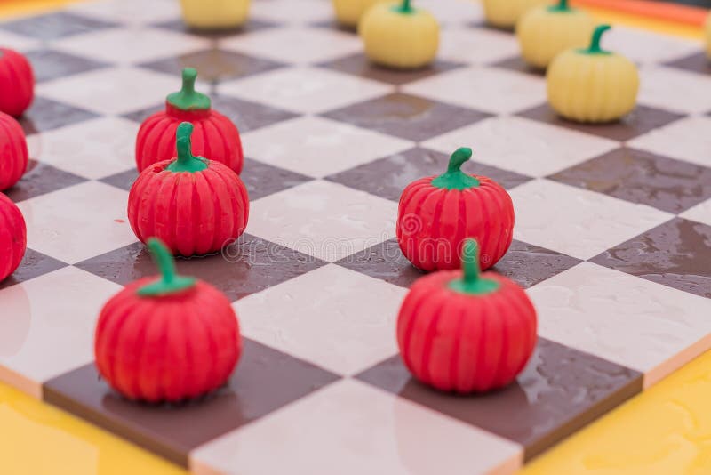 Close Up of Checkered Board with Pumpkin Checkers, Colorful Background ...