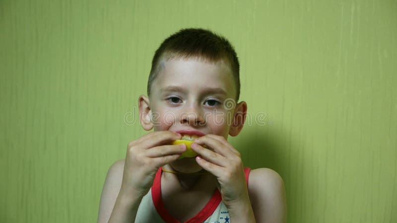 Close Up of a Cheerful Caucasian Boy Tasting Lemon. Stock Video - Video ...