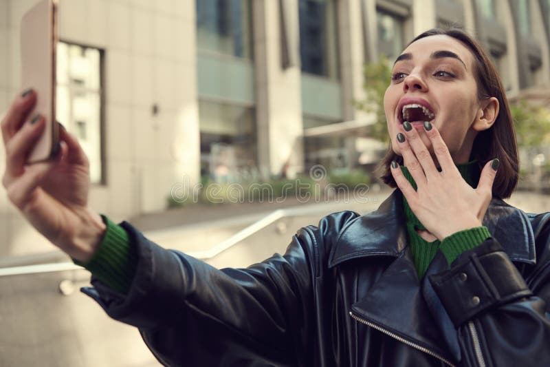 Close Up Of Cheerful Funny Joyful Woman Holding Smartphone In