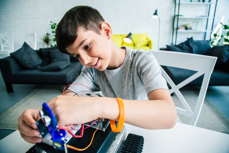 Close Up of a Cheerful Little Boy Constructing a Robotic Device Stock ...