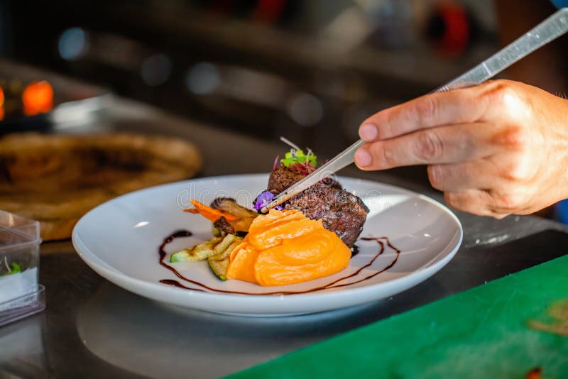 Close Up of Chef Hands in Hotel or Restaurant Kitchen Decorating Dish ...