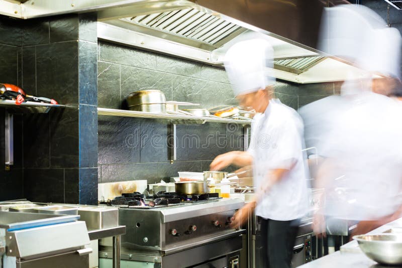 Cook in industrial kitchen stock photo. Image of interior - 34864862