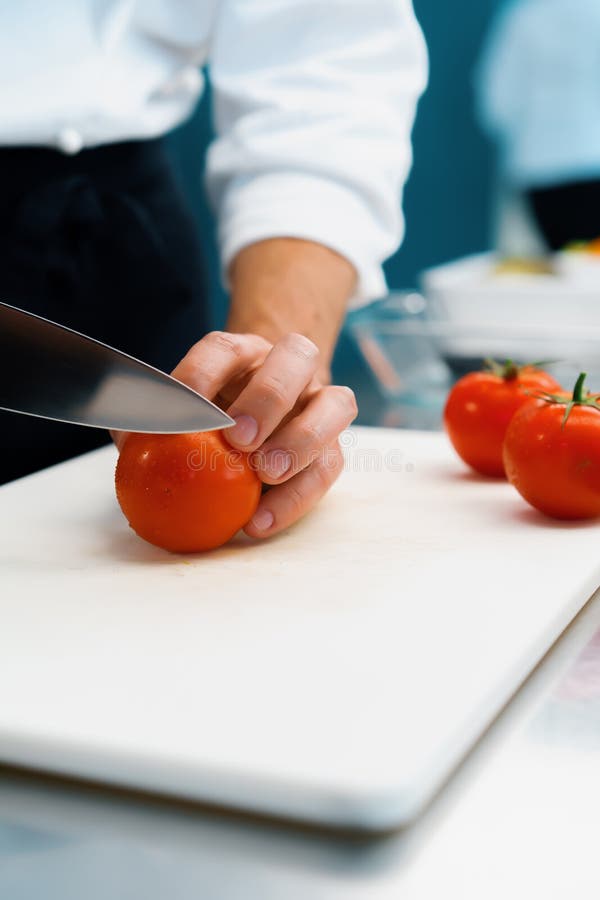 Close-up of a Chef Slicing Tomato in a Professional Restaurant Kitchen ...
