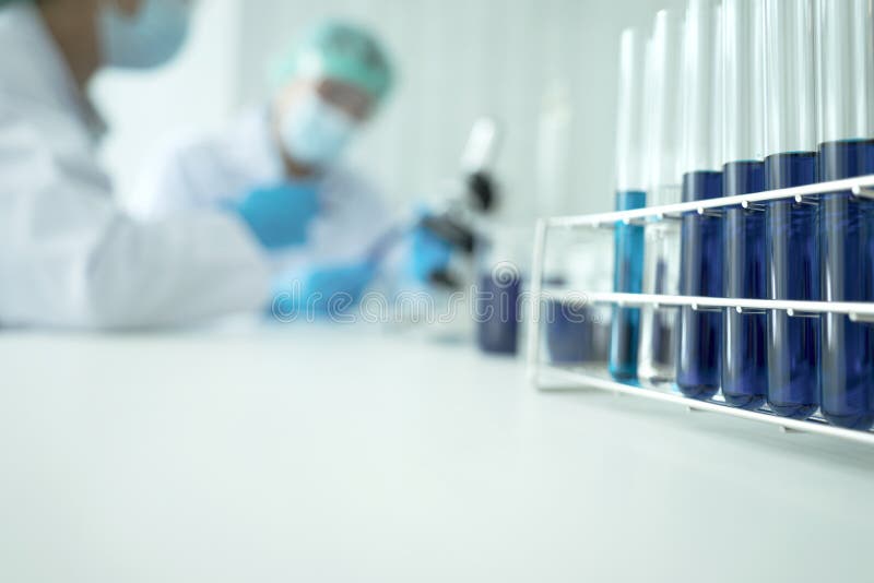 Close Up Chemical Test Tubes with Scientists Stock Photo - Image of ...