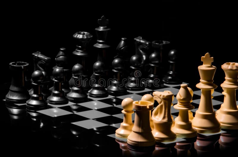 Close Up of Chess Pieces on a Reflective Mirror Board Surface with ...