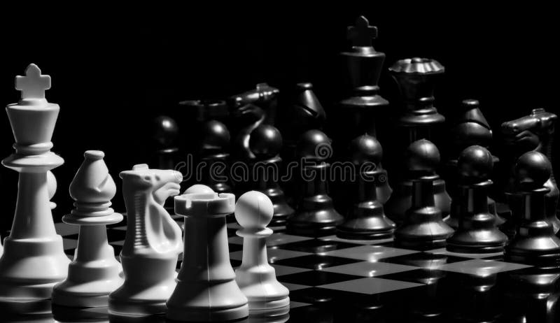 Close Up of Chess Pieces on a Reflective Mirror Board Surface with ...