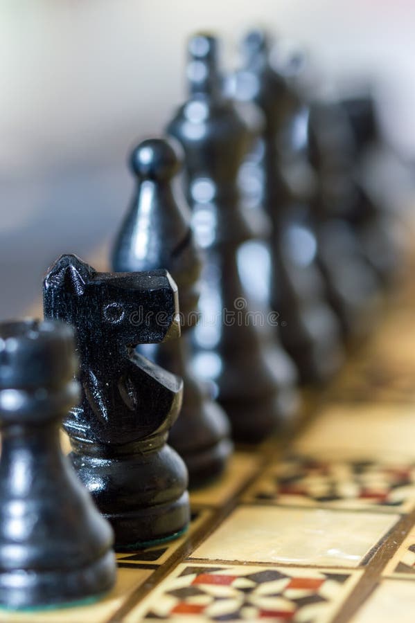 Close Up of Chess Pieces on a Reflective Mirror Board Surface with ...
