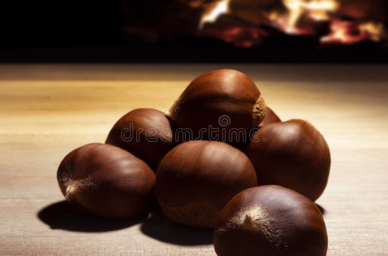 Close Up of Chestnuts Ready To Roast with Fire Behind Stock Photo ...