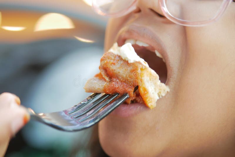Close-Up of Child Enjoying Delicious Food Bite in a Modern Setting ...