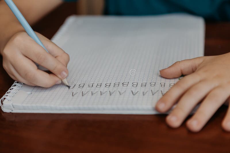 Close Up of Child Writing Letters in Notebook Stock Photo - Image of ...