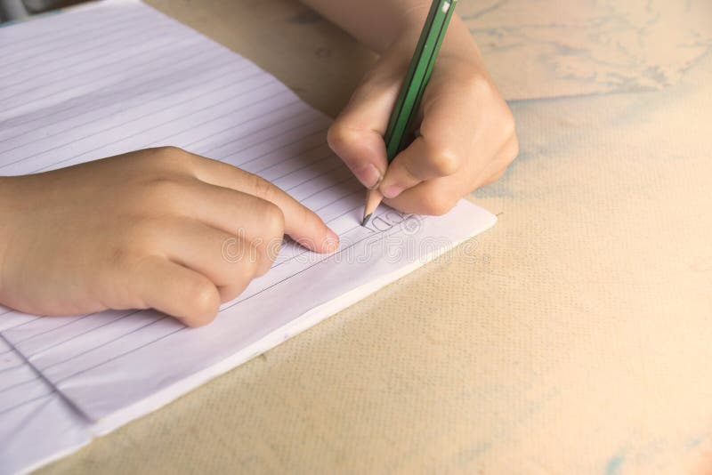 Close Up Children are Holding a Pencil and Writing. Stock Photo - Image ...