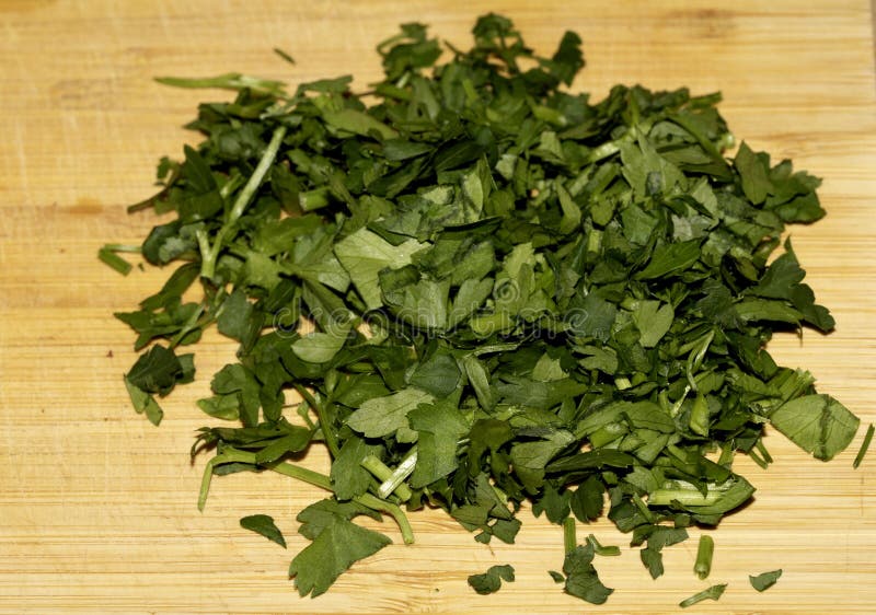 Close Up of Chopped Persley Herbs on a Wooden Chopping Board Stock ...