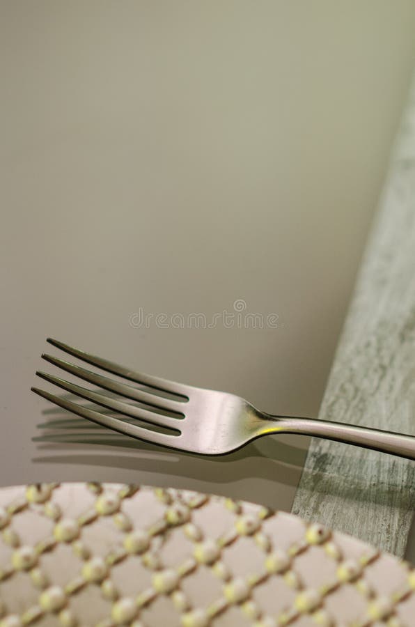 Close Up of a Chrome Fork with a Silver Plate on One Side on a ...