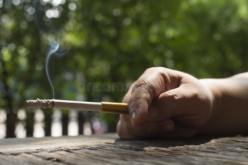 Close up Cigarette in hand stock photo. Image of male - 56403182