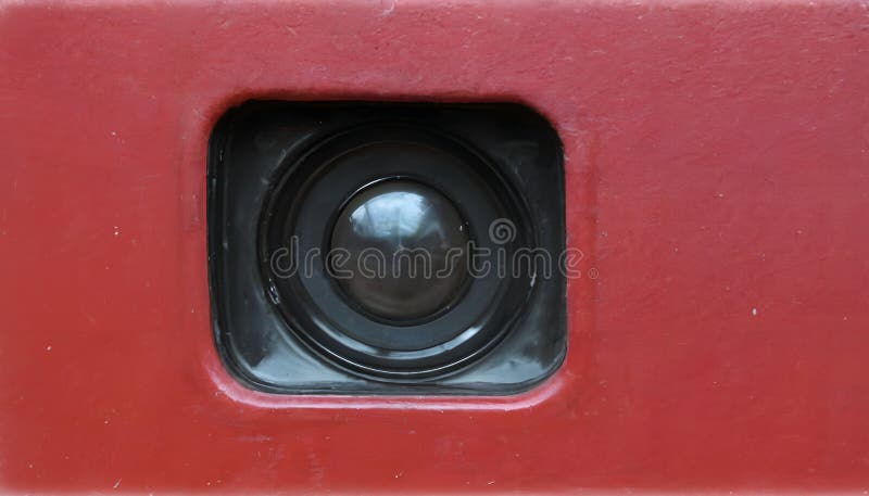 Close-up of a Circular Lens Embedded in a Red Metal Surface Stock Photo ...
