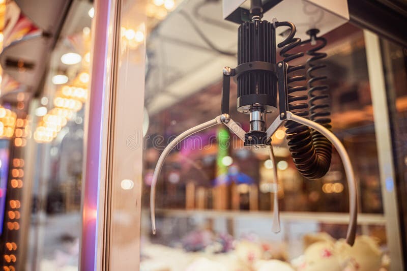 Close-up of the Claw Machine Arcade Game in an Evening Amusement Park ...