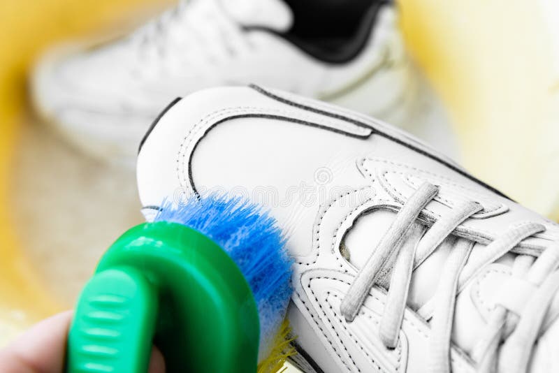 Close Up of Cleaning White Sneakers with a Brush and Detergent in a ...